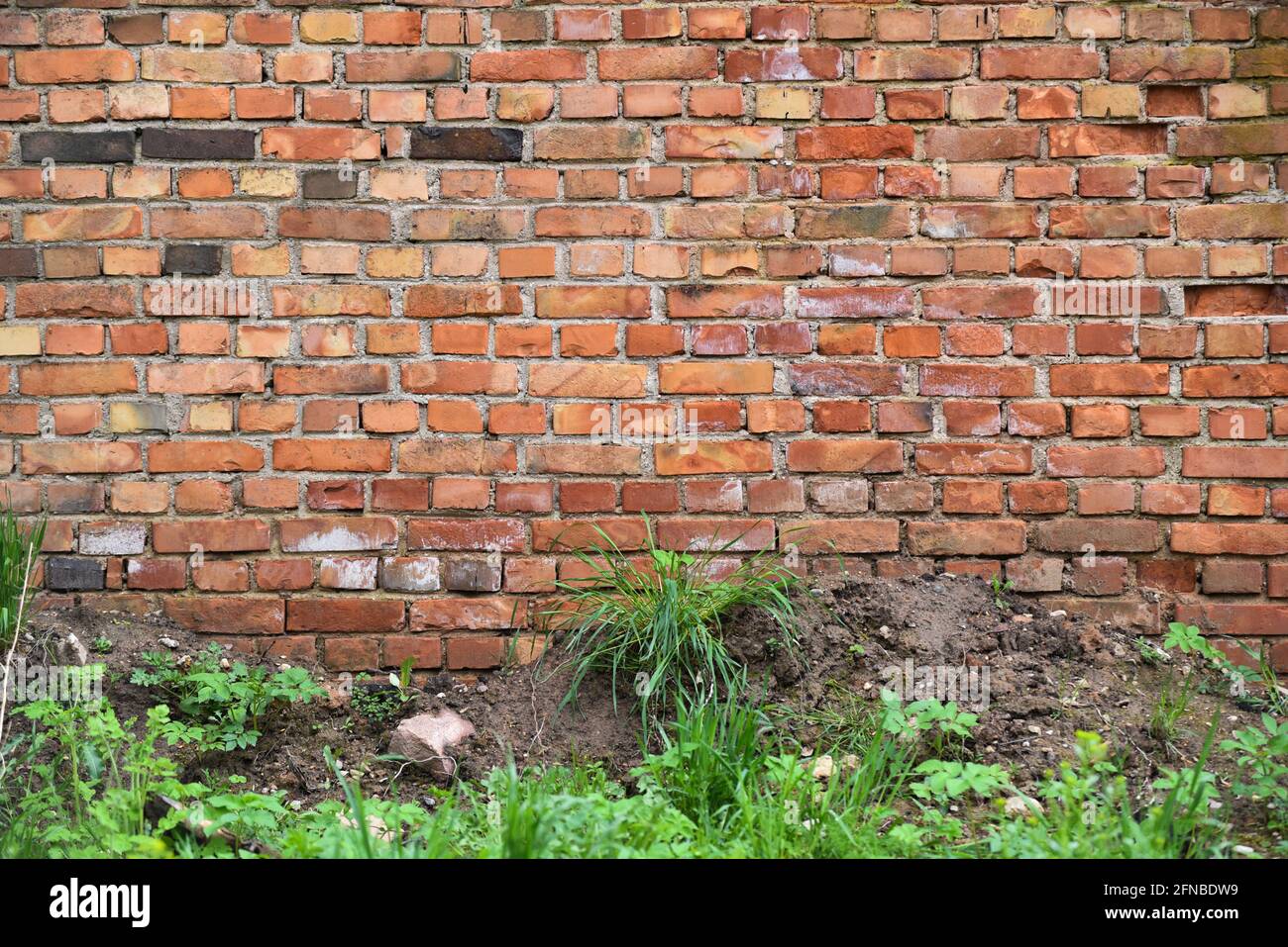 building wall facade of an old house made of cracked red brick ...