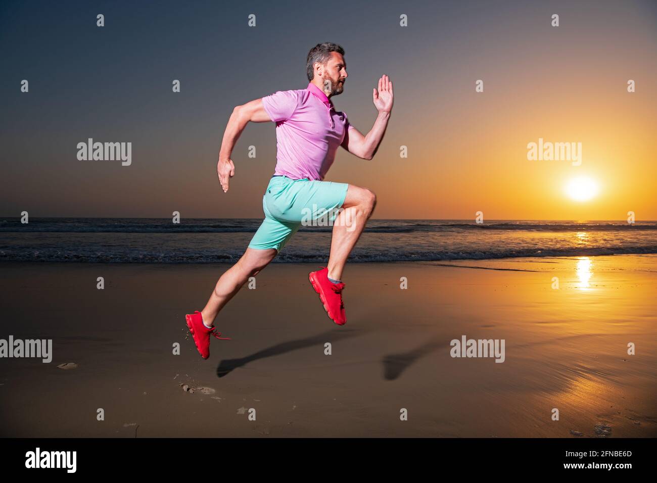 Sporty man runner running in summer sea beach. Attractive fit man run ...