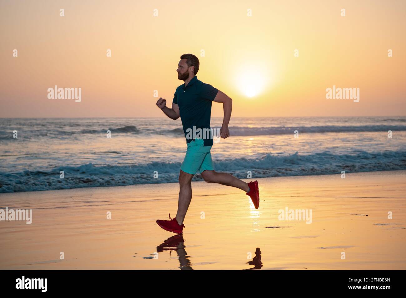 Sporty man runner running in summer. Man running on the beach at sunset ...