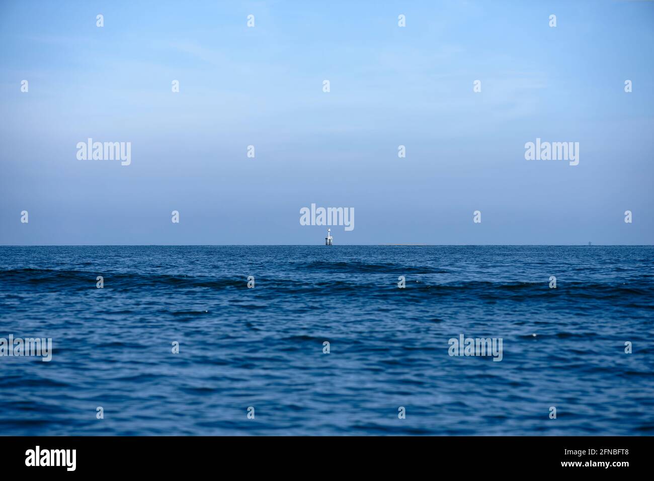 Minimal Ocean and sky with mysterious building Stock Photo - Alamy