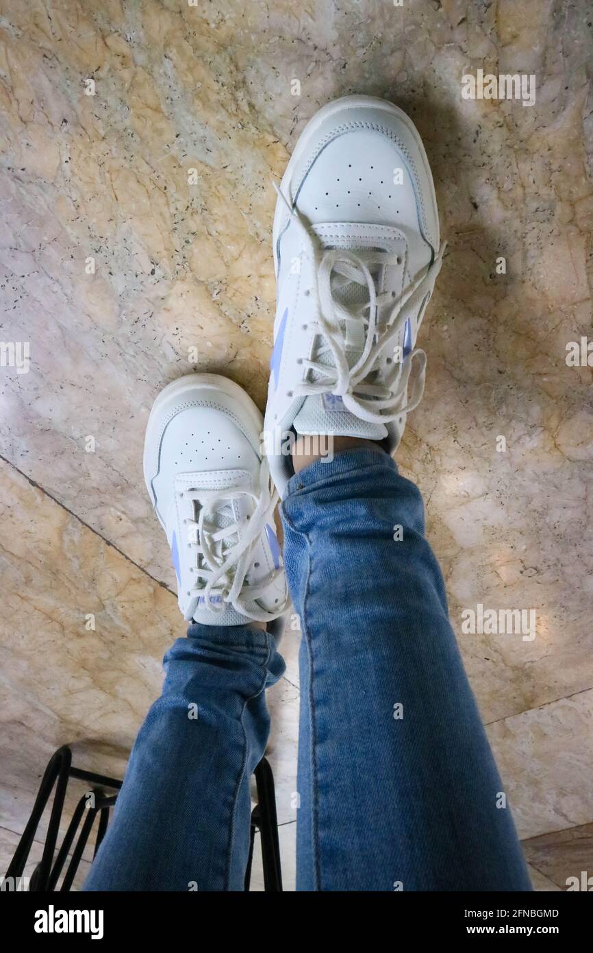 Top view of female feet wearing white sneakers hi-res stock photography ...