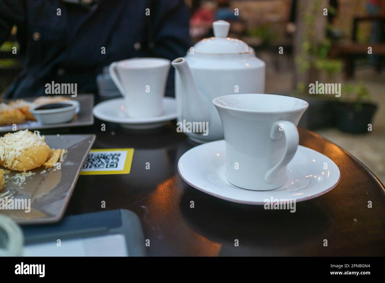 teapot and white teacup on the table photo Stock Photo - Alamy