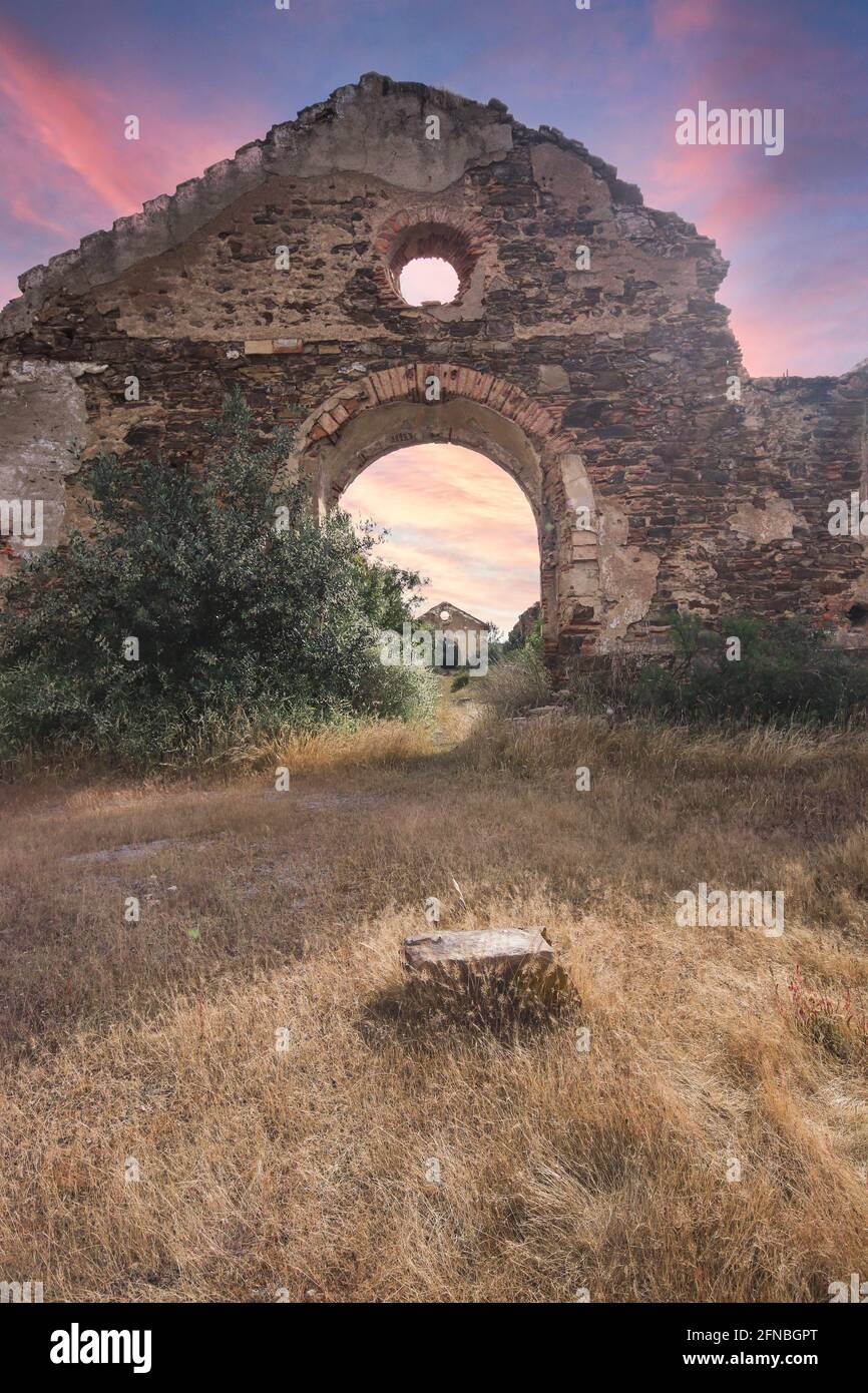 Ruins of an old factory at the sunset. Old building covered by ...