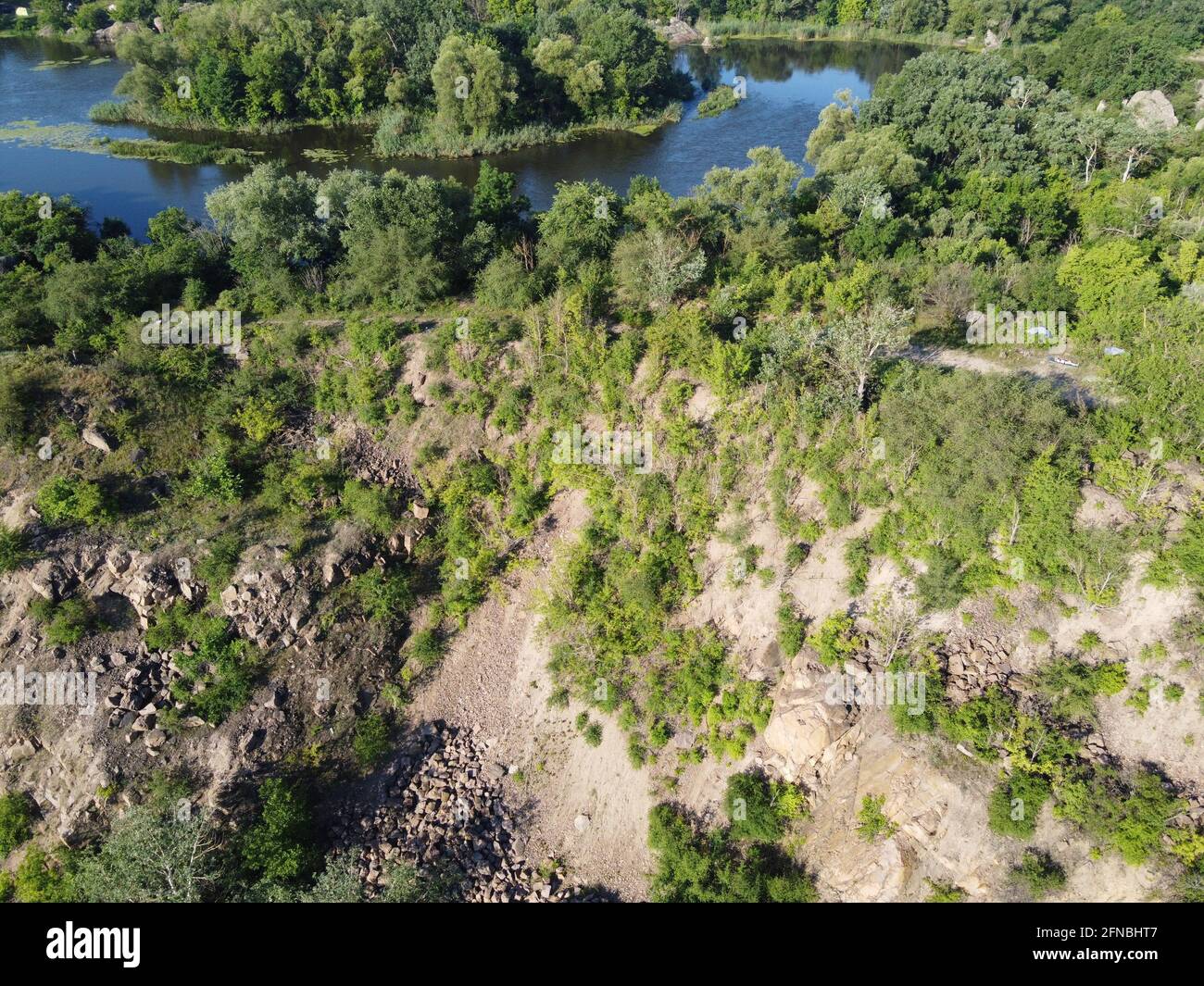 Rocky terrain overgrown with sparse vegetation, aerial view. Summer ...
