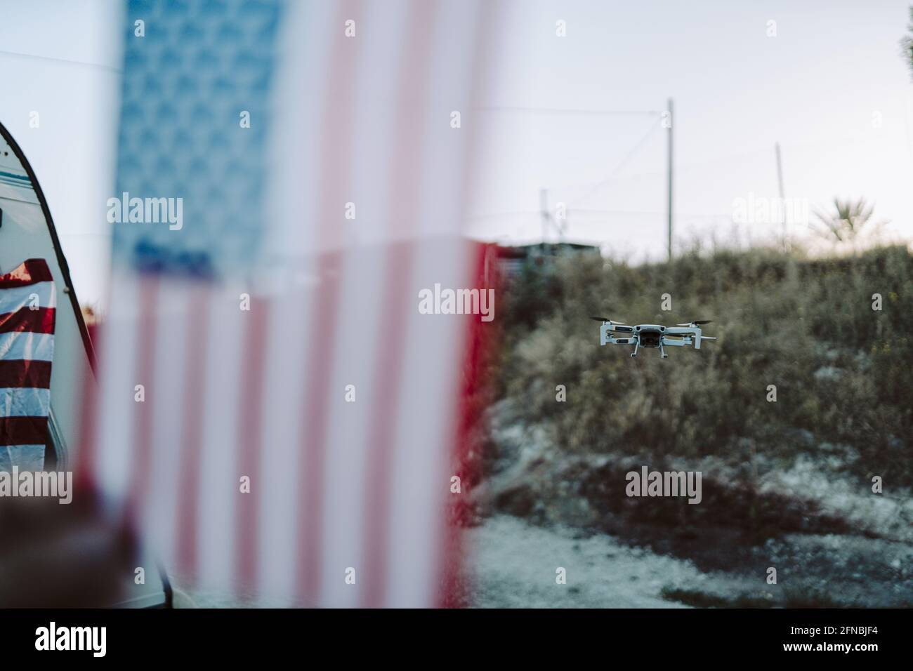 An American flag and a shooting drone in the air Stock Photo - Alamy