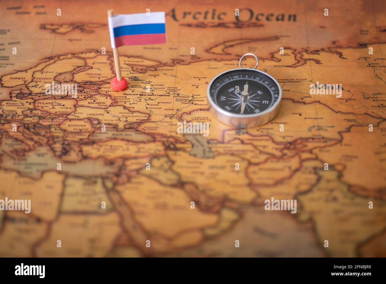 Russian flag on the world map and compass. The concept of travel and ...