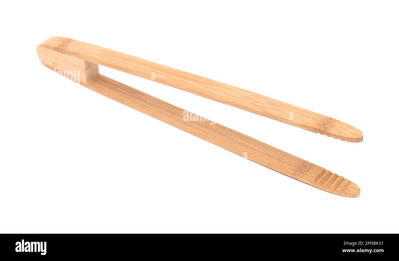 Long kitchen tongs made on bamboo wood isolated on white background ...