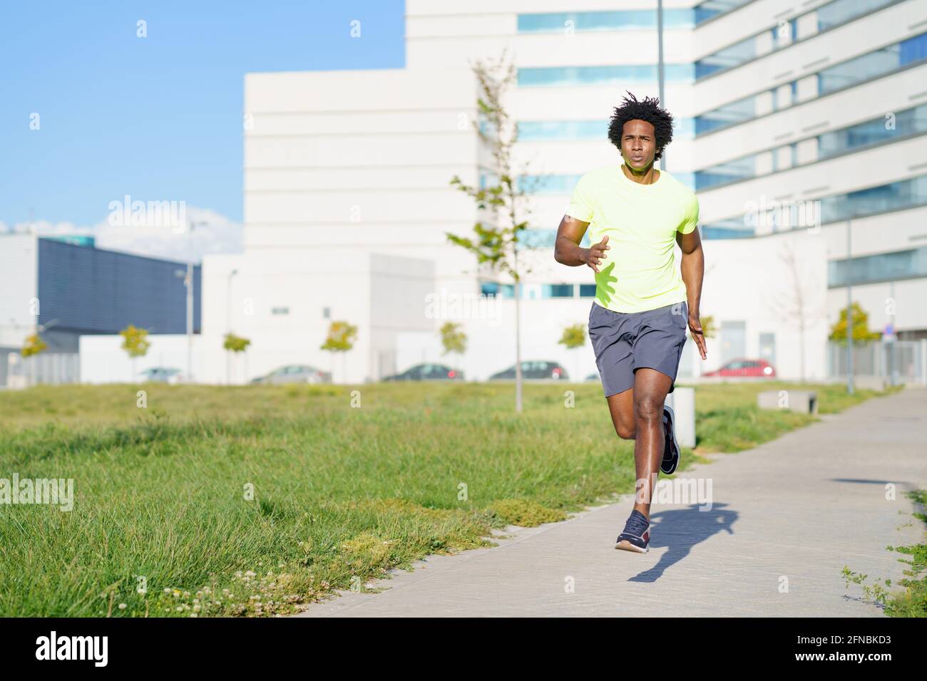 Black athletic man running in an urban park Stock Photo - Alamy