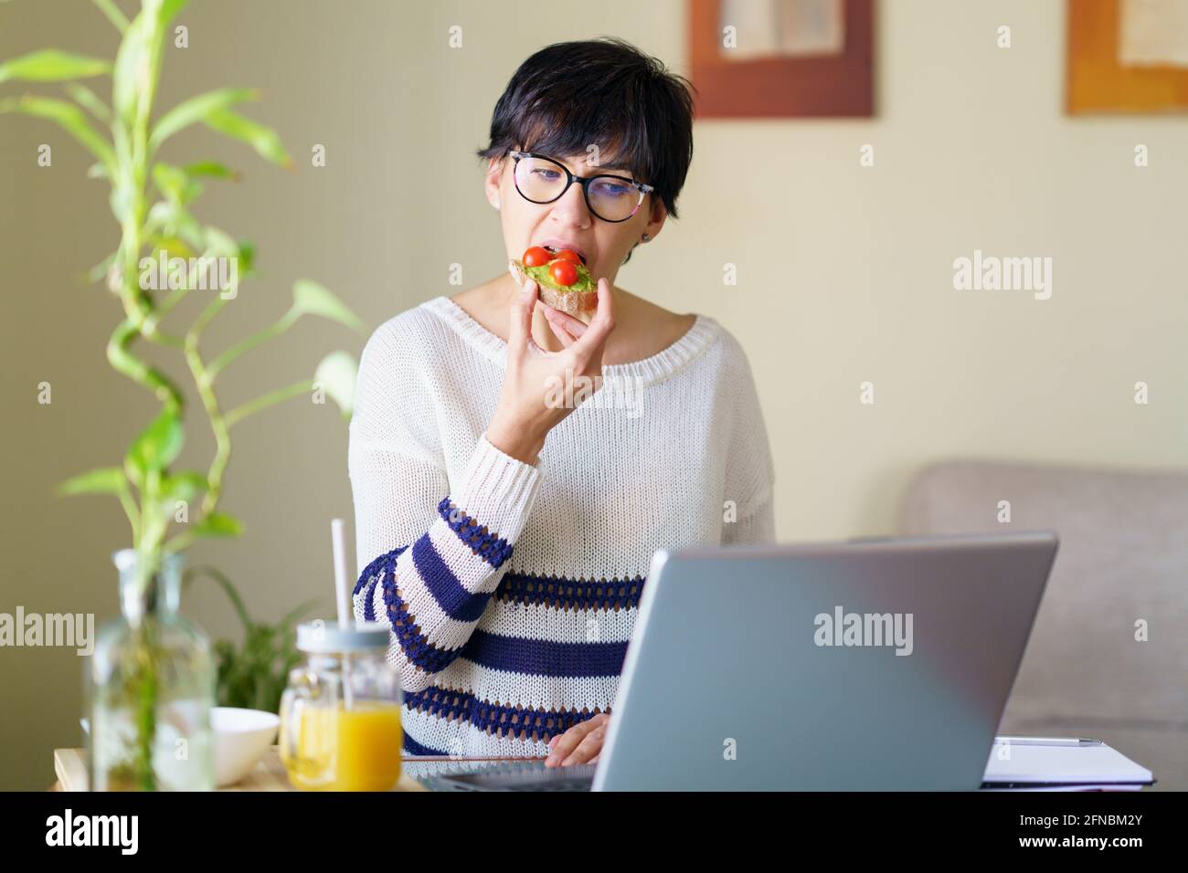 Lady healthy eating working from home hi-res stock photography and ...
