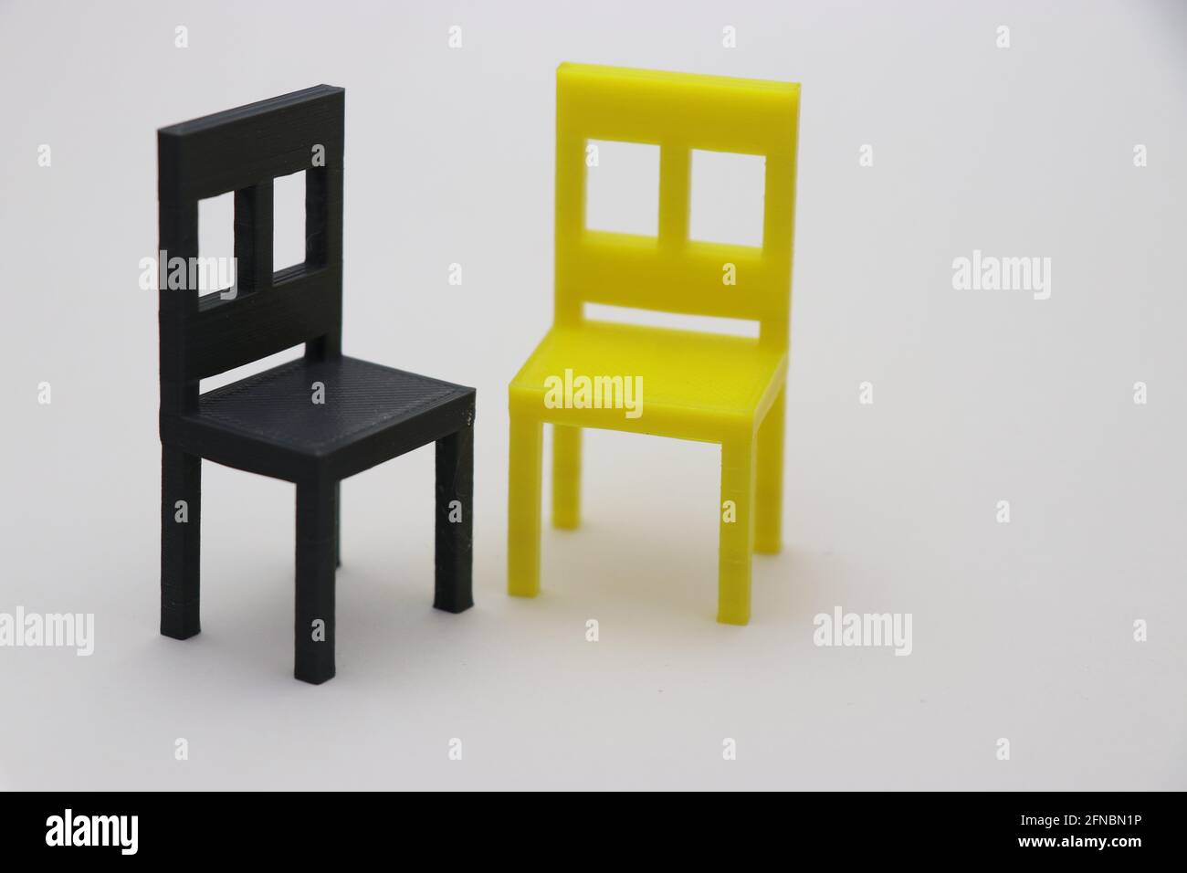 3D Printed small chairs on white background. 3D Printing technology ...