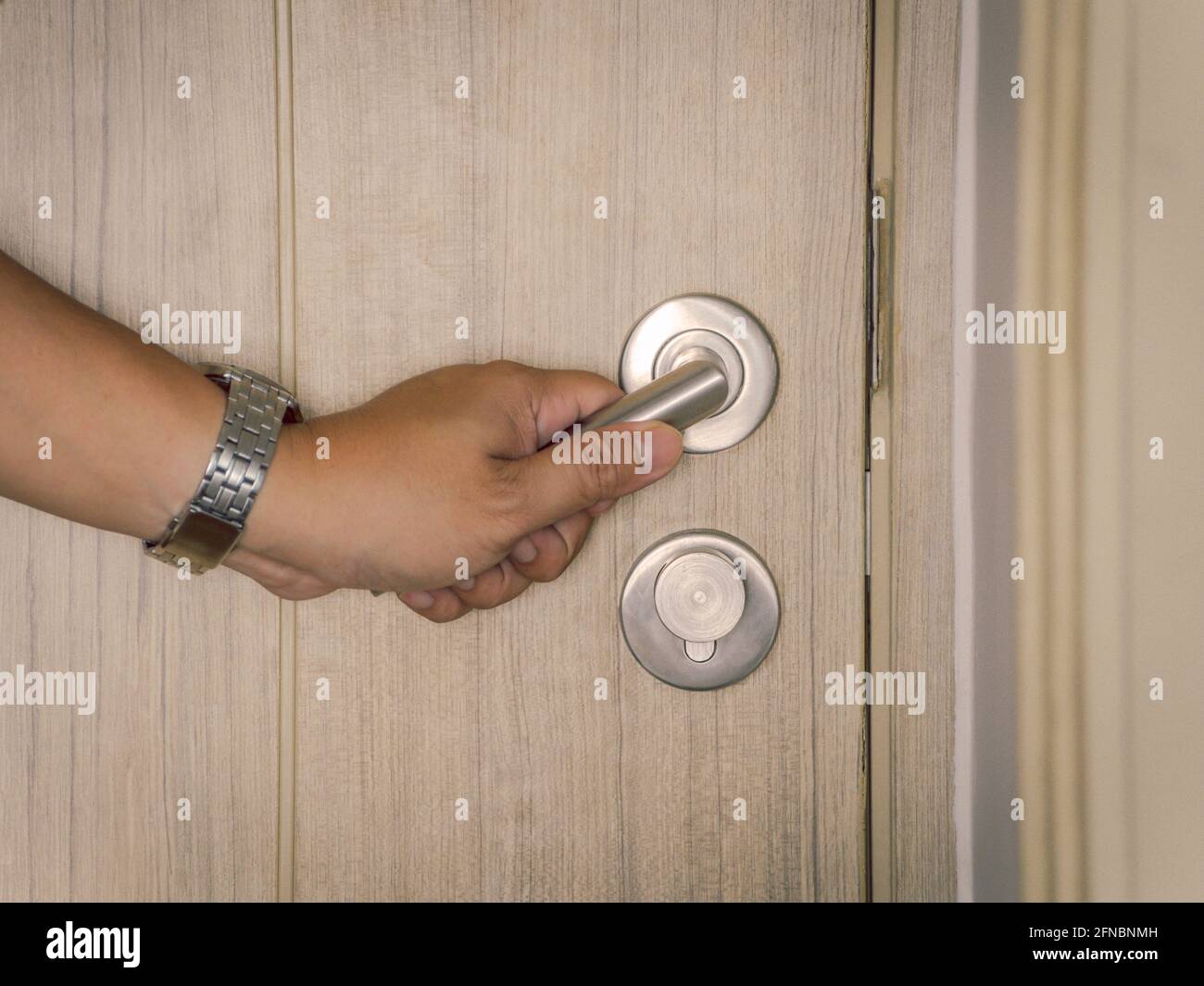 Hand closing entrance door hi-res stock photography and images - Alamy