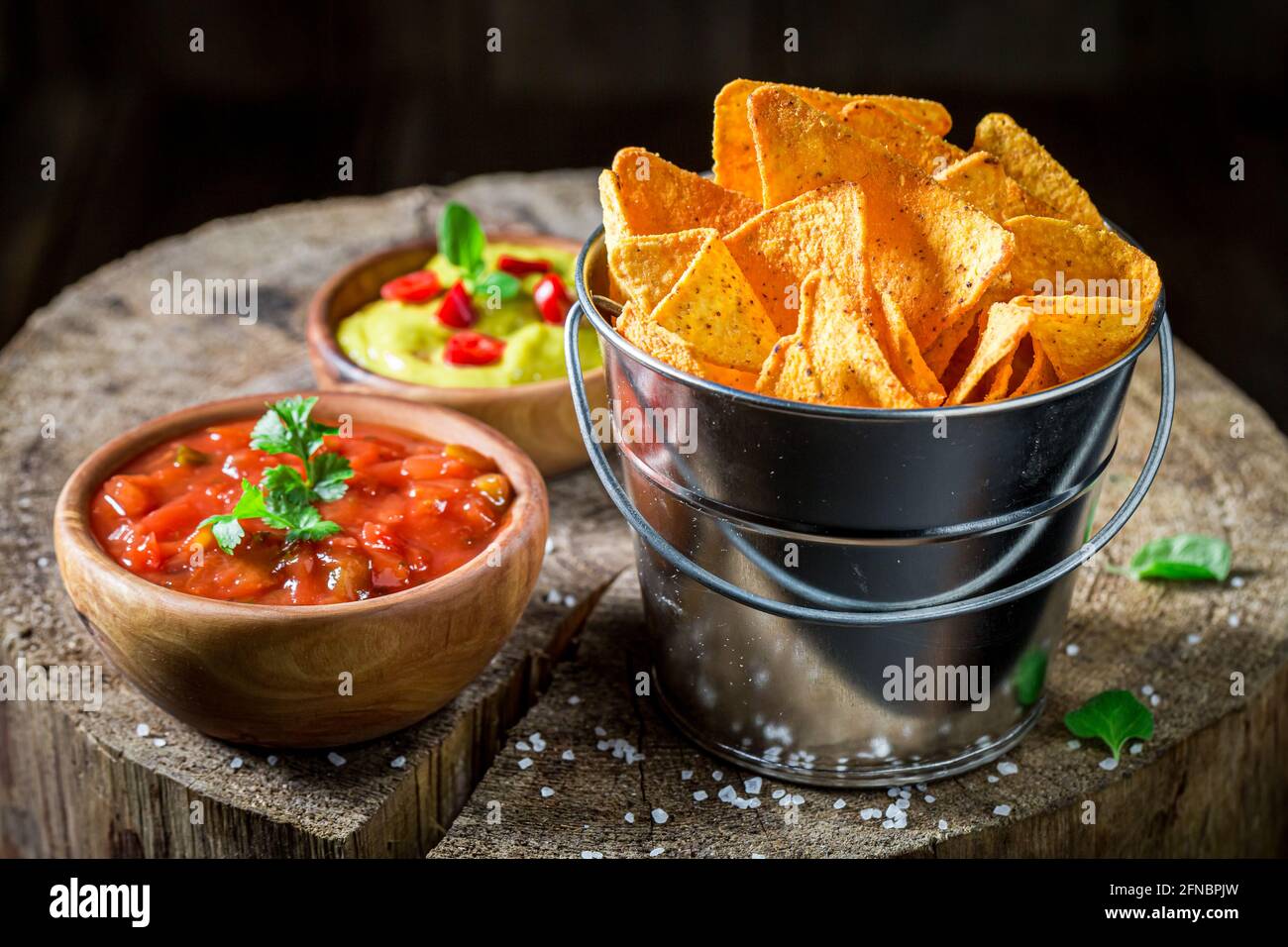 Nachos with salt and spicy red sauce. Mexican snack popular in the ...