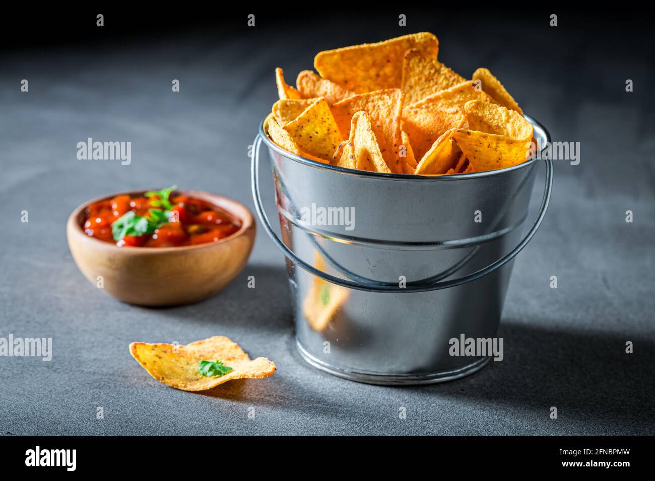 Mexican snack popular in cinema. Golden nachos in metal bucket Stock ...
