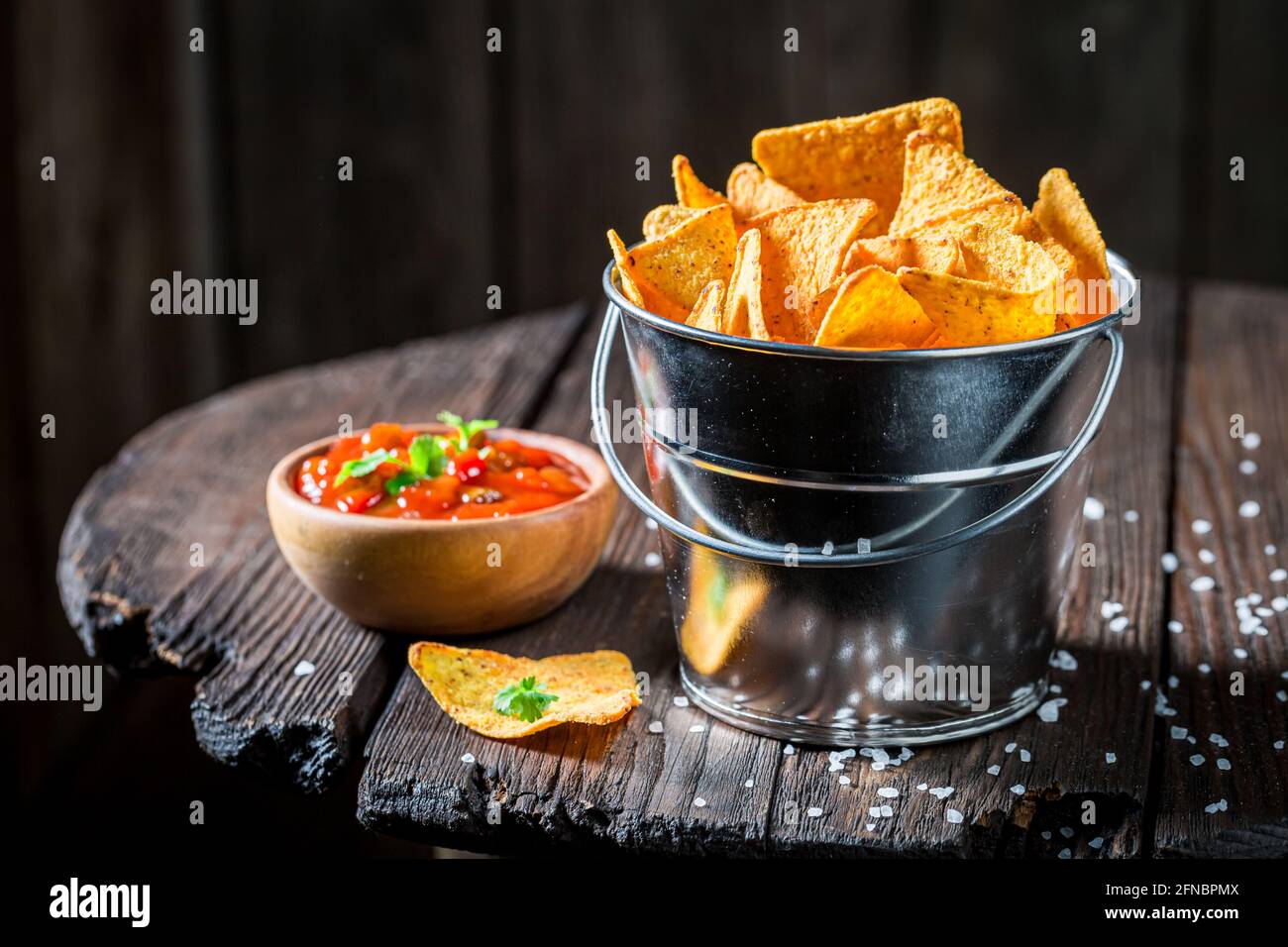 Golden nachos with salt and spicy red sauce. Mexican snack popular in ...