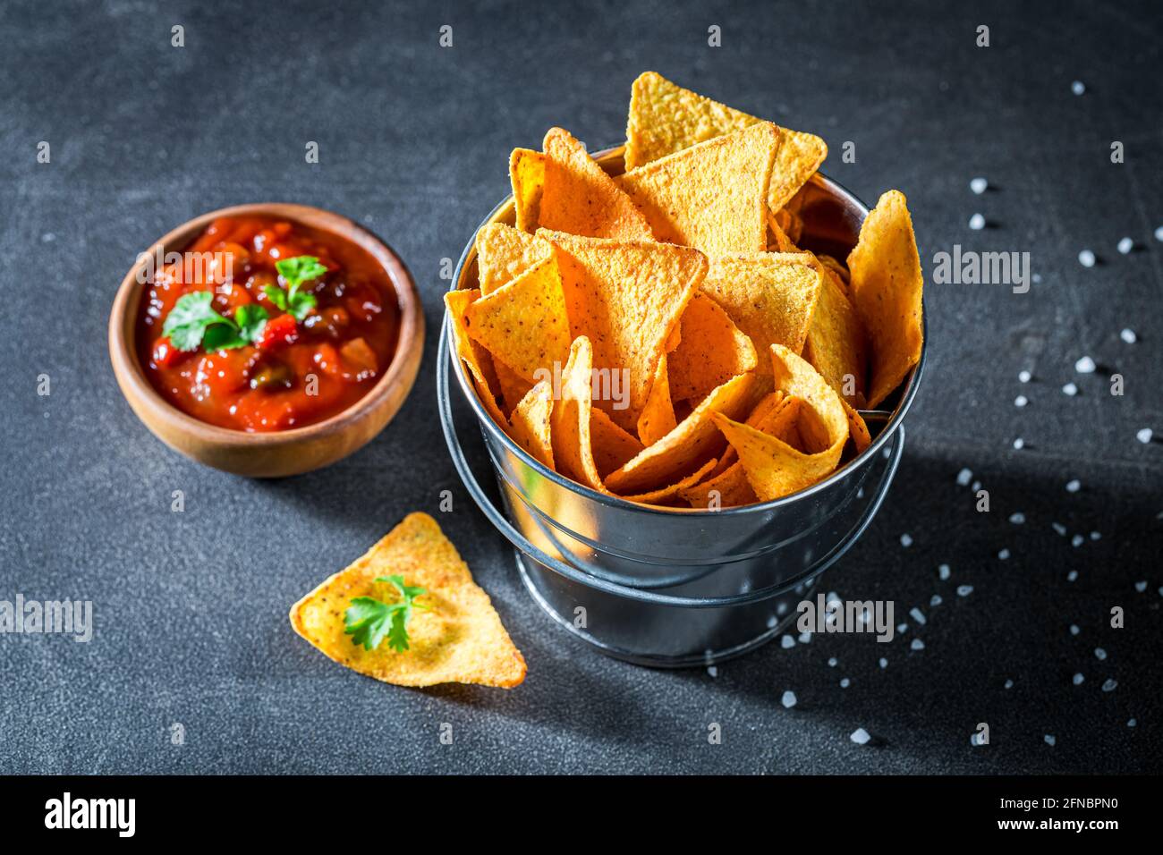 Top down view of nachos in metal bucket with tomato sauce Stock Photo ...