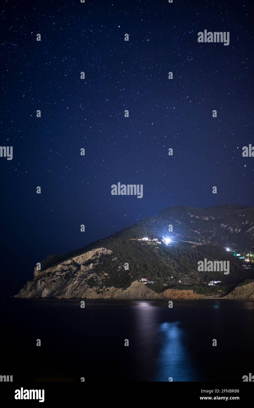 Starry night over the island of Skopelos, Greece. View from the harbor ...
