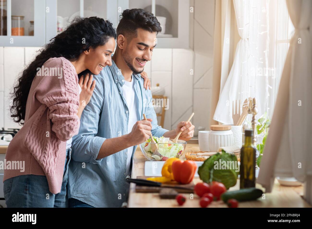 Cooking Together. Happy millennial middle eastern couple preparing food ...