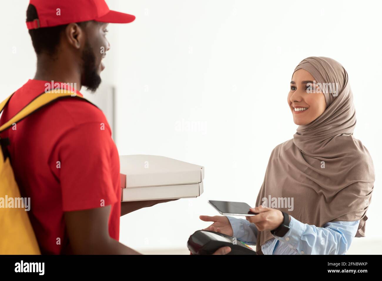 Black man transaction mobile phone hi-res stock photography and images ...