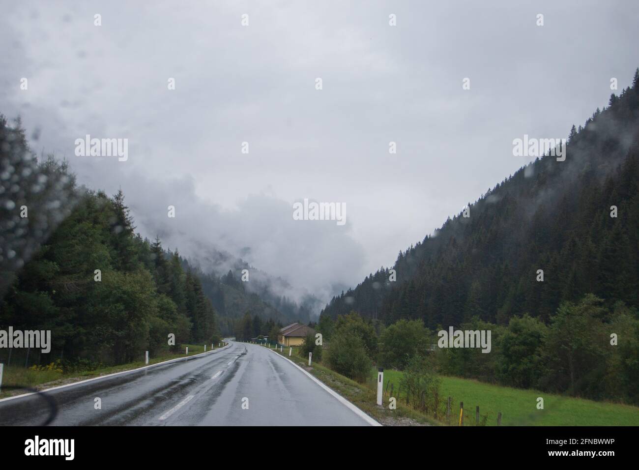 A road through central Austria in a very wet, rainy and cloudy Autumn ...
