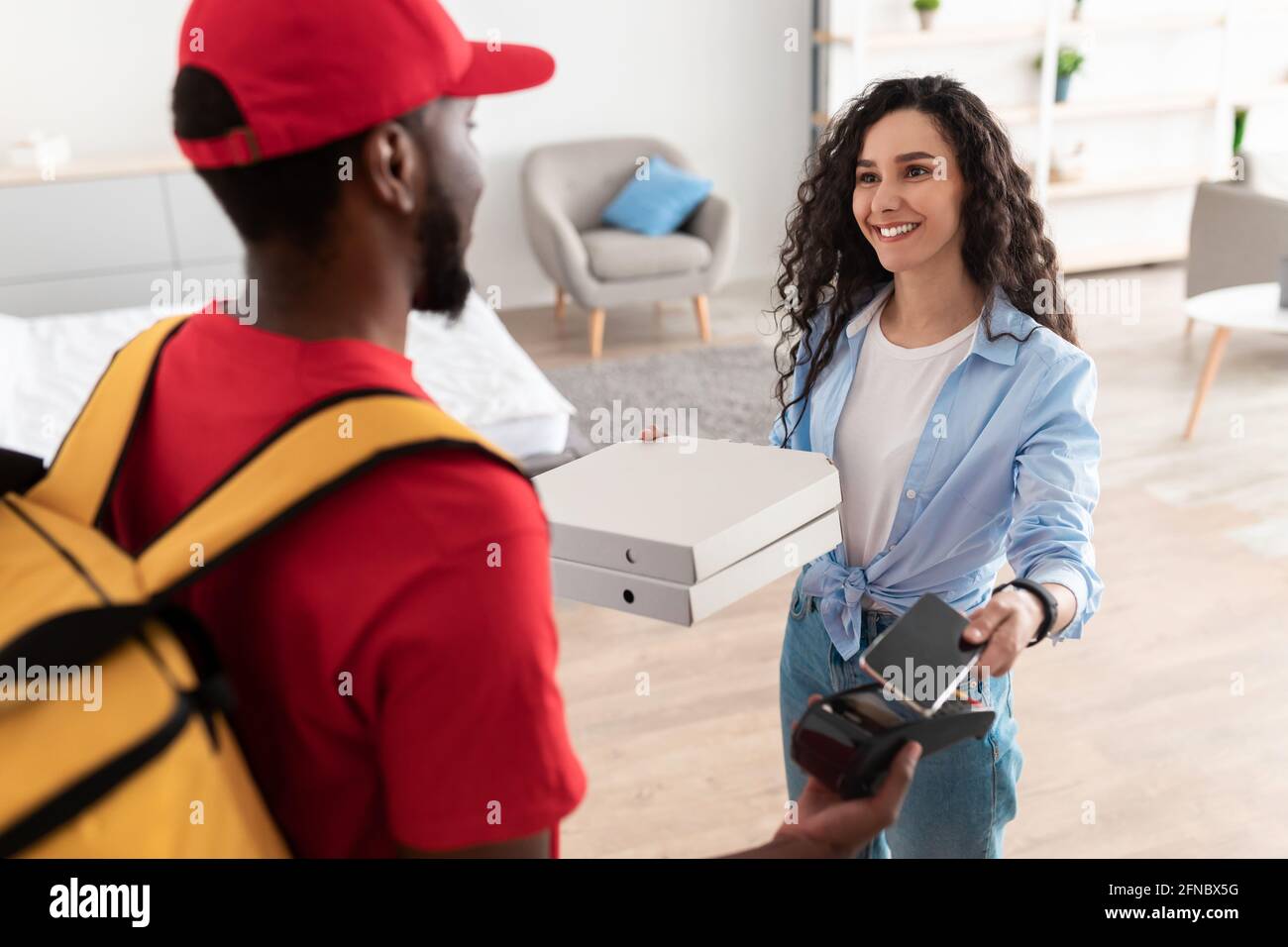 Black man transaction mobile phone hi-res stock photography and images ...