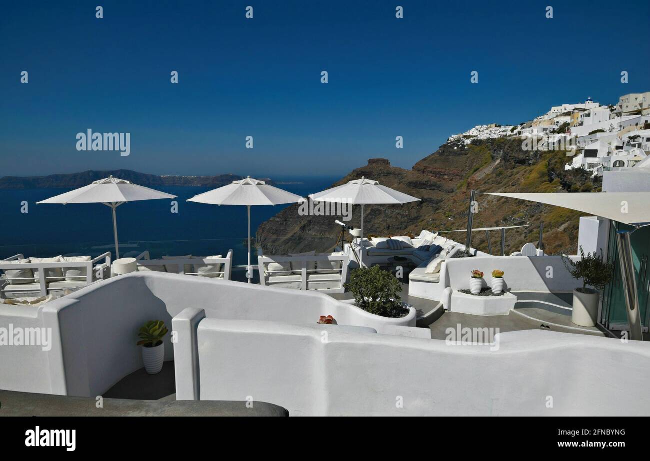Scenic luxury resort veranda with white parasols overlooking the Aegean ...