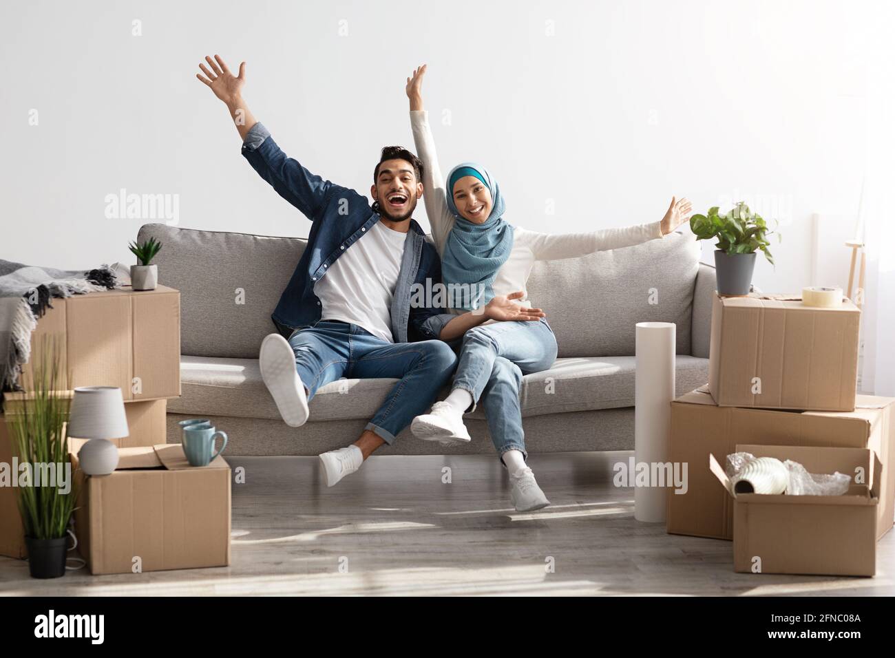 Emotional muslim family celebrating moving to their new house Stock ...