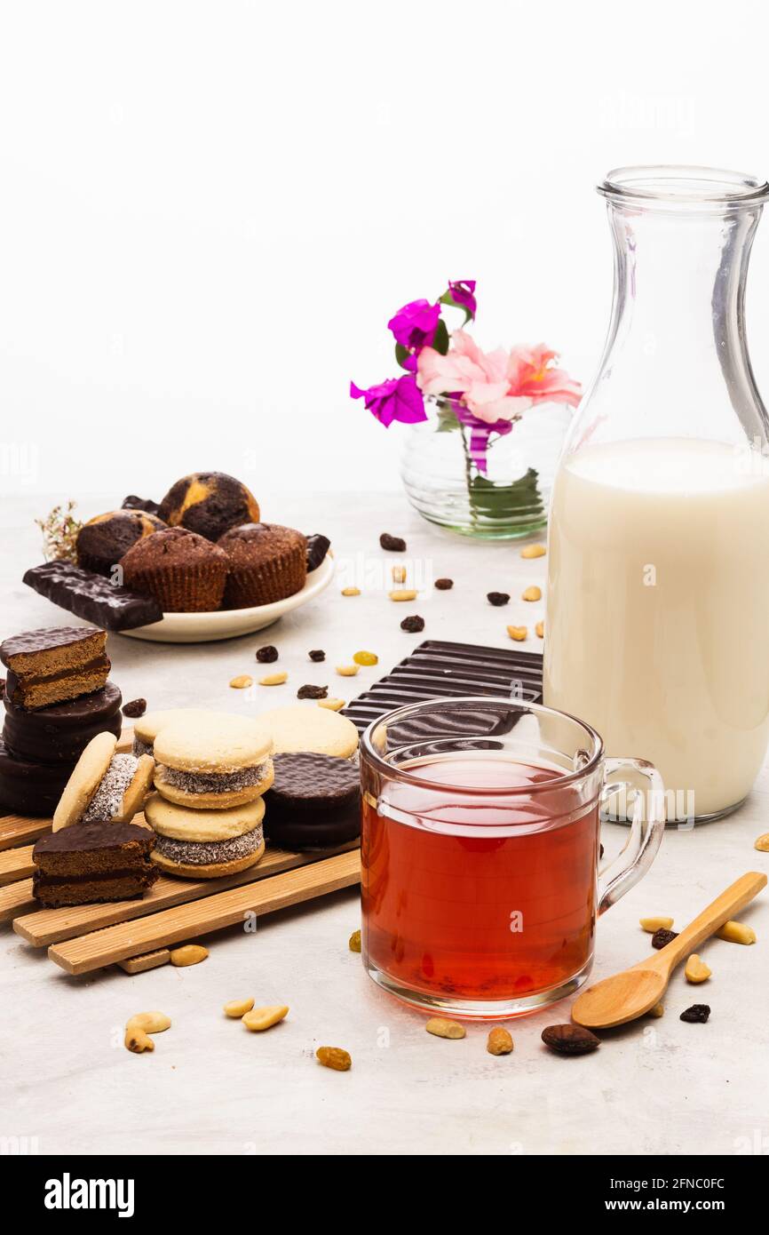 The sweet breakfast table - milk, tea, nuts and muffins Stock Photo - Alamy