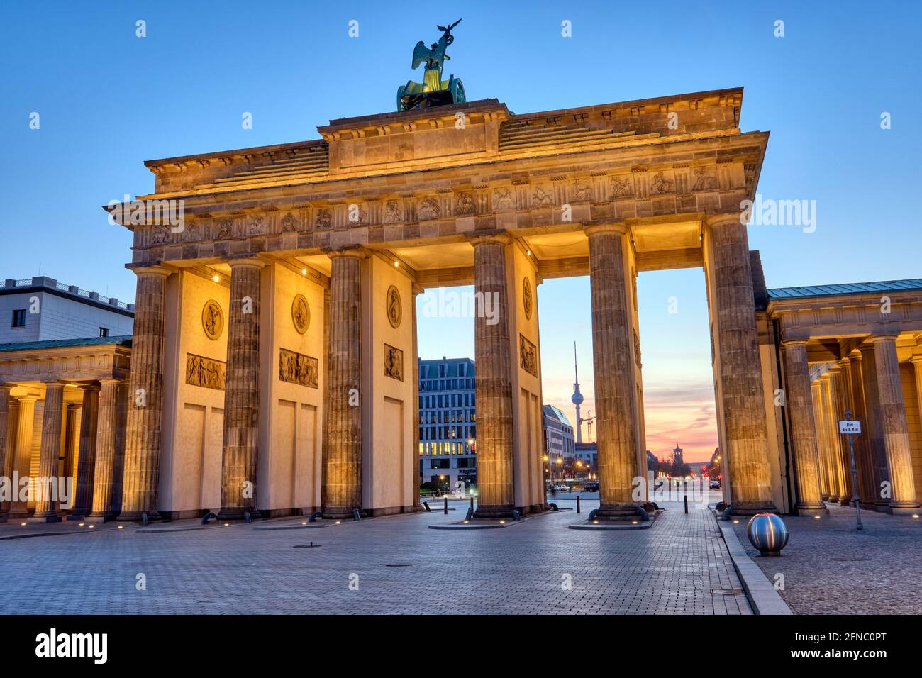 The Brandenburg Gate with the TV Tower in the back before sunrise, seen ...