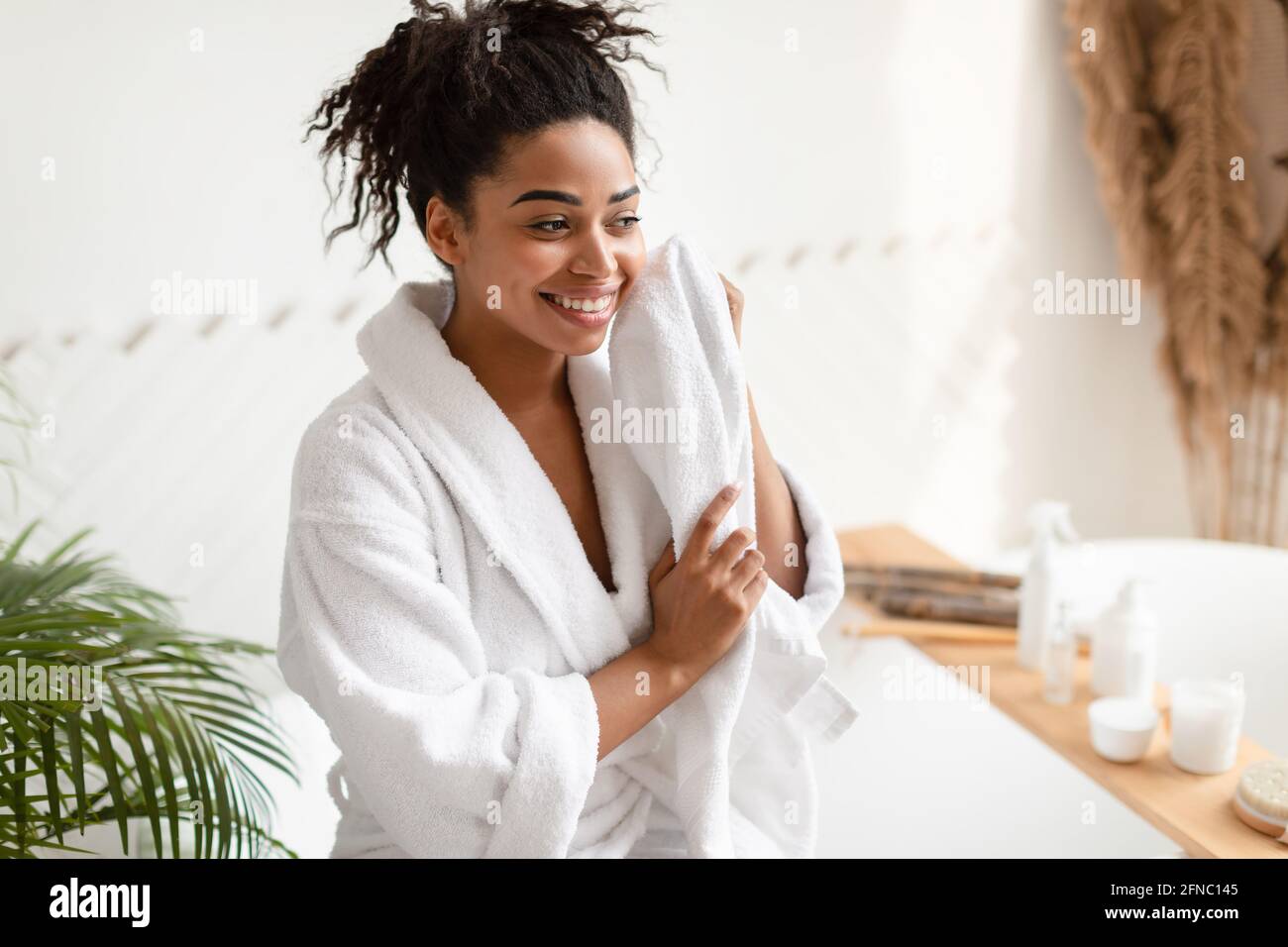 Black Lady Drying Face With Towel In Bathroom Stock Photo - Alamy