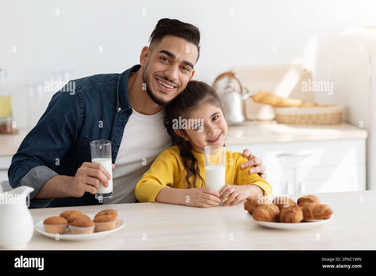 Cute Little Arab Girl Having Snacks With Daddy In Kitchen Stock Photo ...