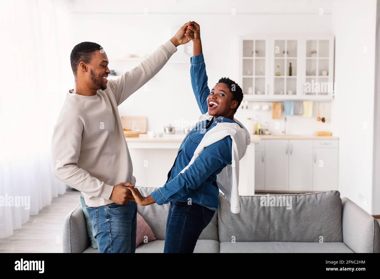 Portrait of joyful black couple dancing at home Stock Photo - Alamy
