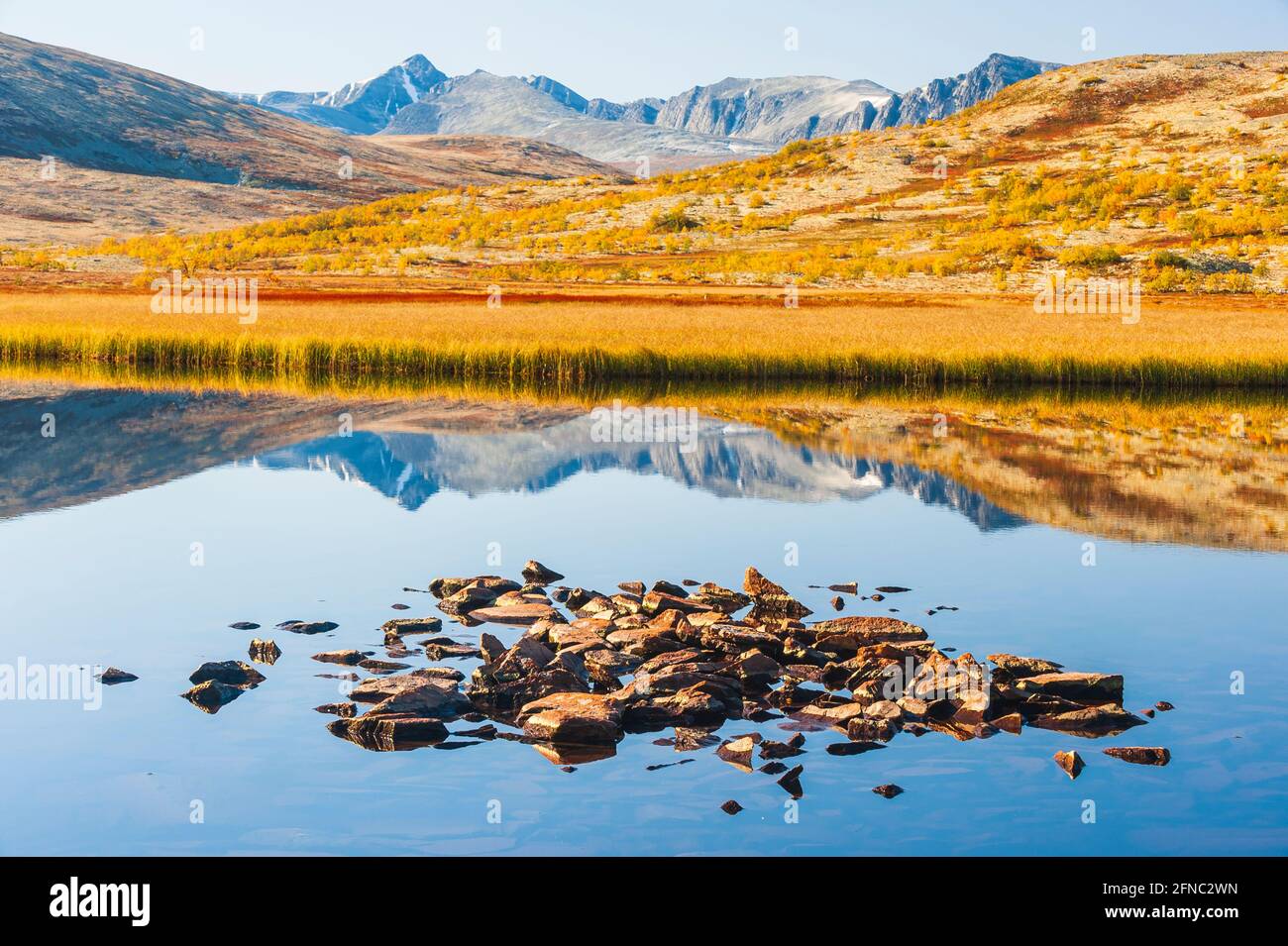 Reflection of mountains in still lake Stock Photo - Alamy