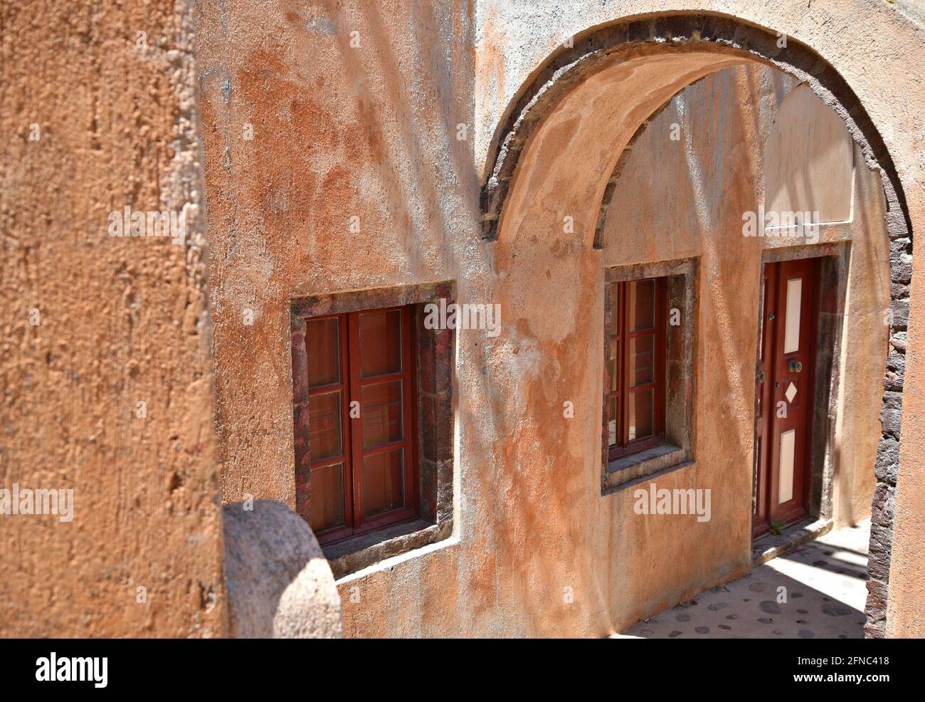 Traditional Adobe house arched facade with a weathered Venetian stucco ...