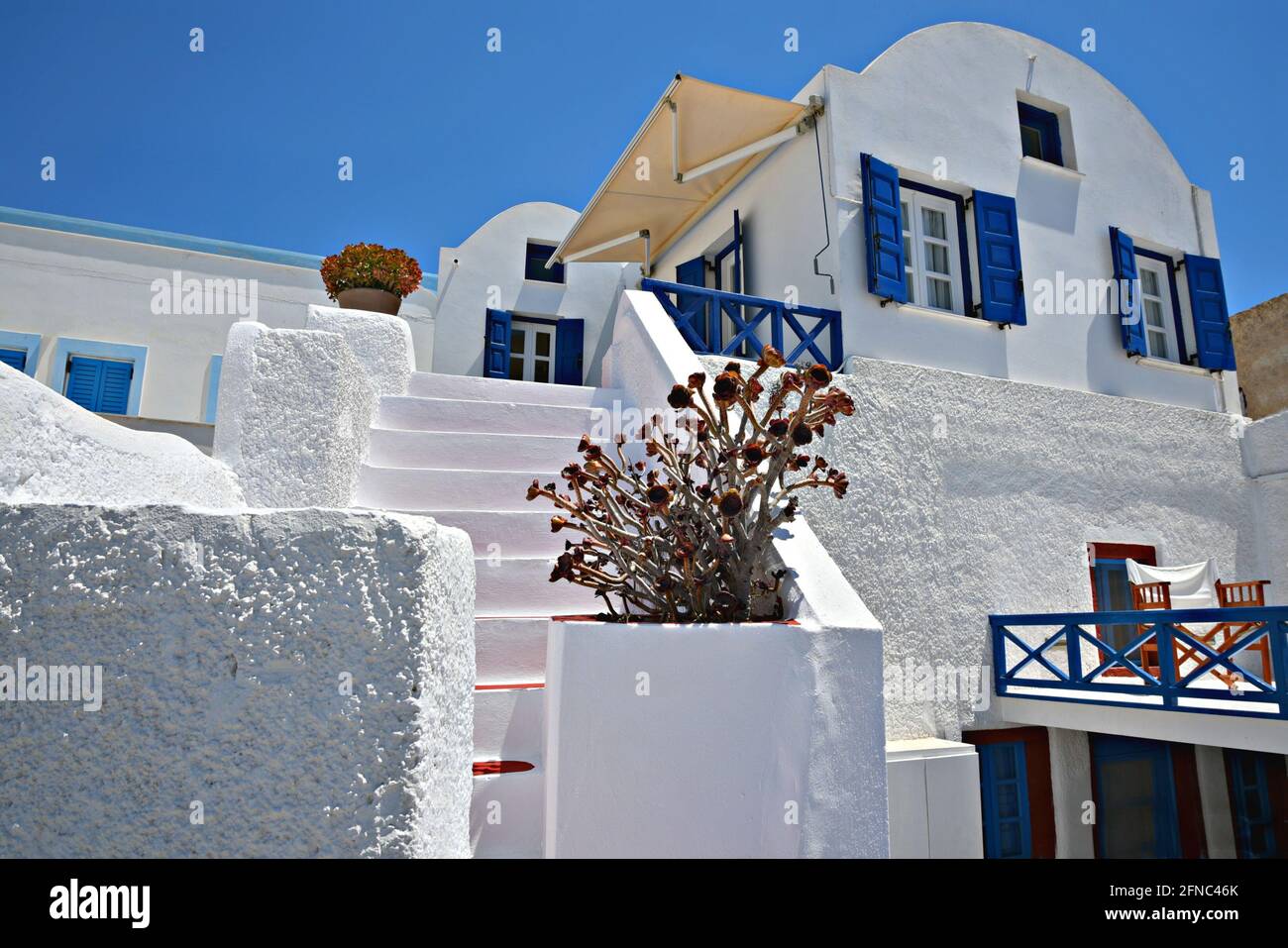 Traditional Cycladic architecture whitewashed house with blue window ...