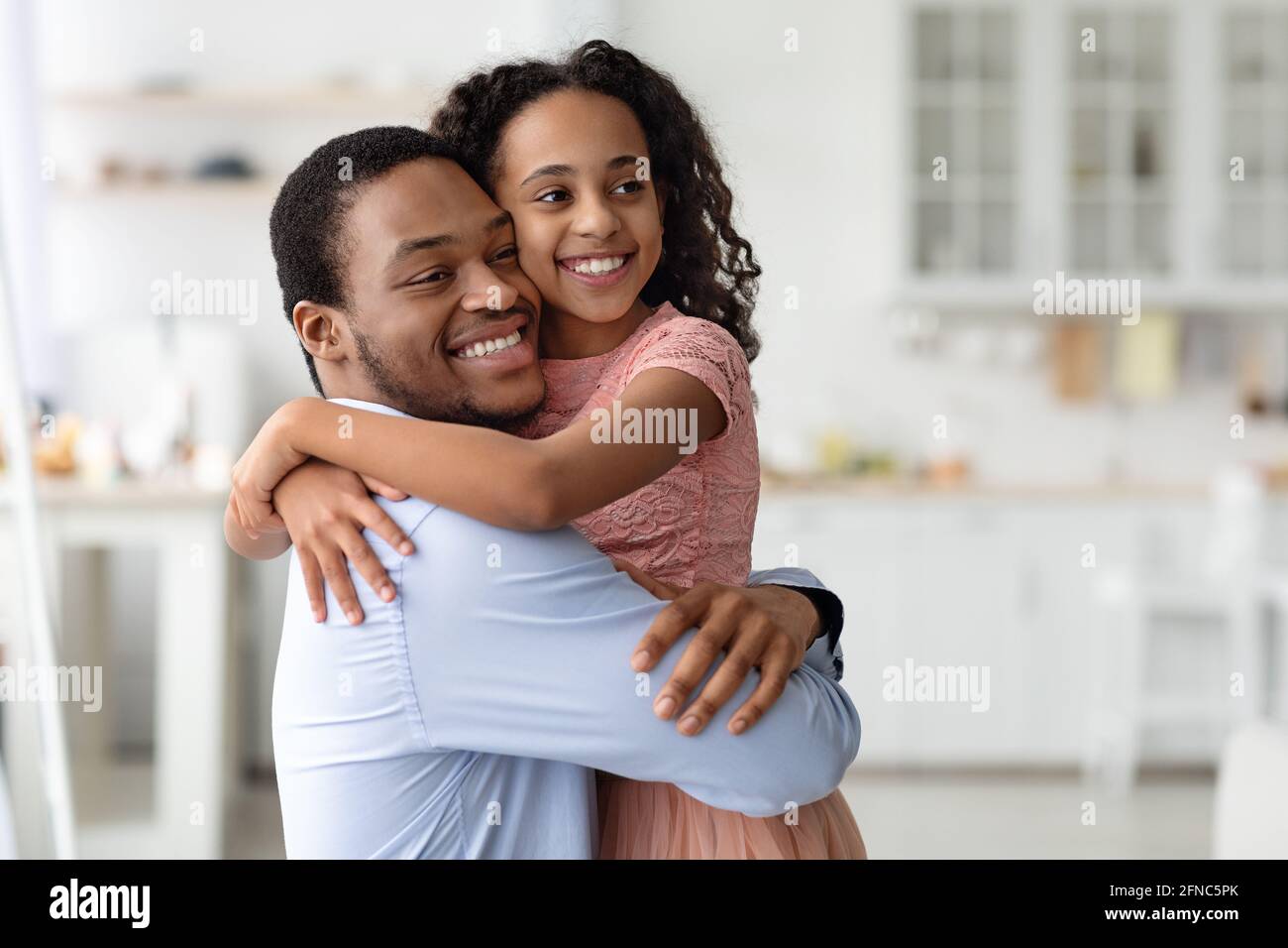 Loving black family father and daughter hugging, copy space Stock Photo - Alamy