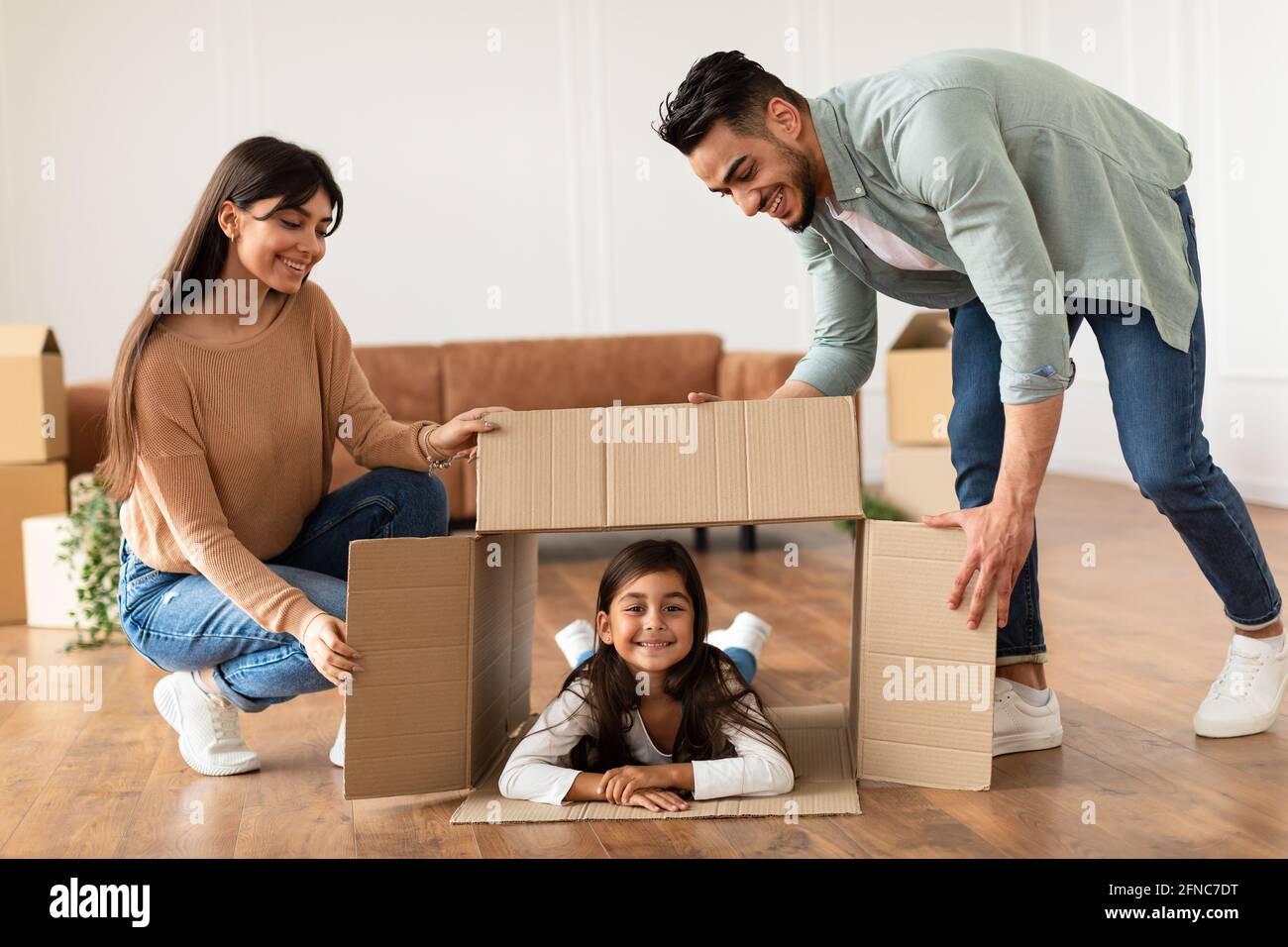 Happy loving young family celebrating relocation together Stock Photo ...