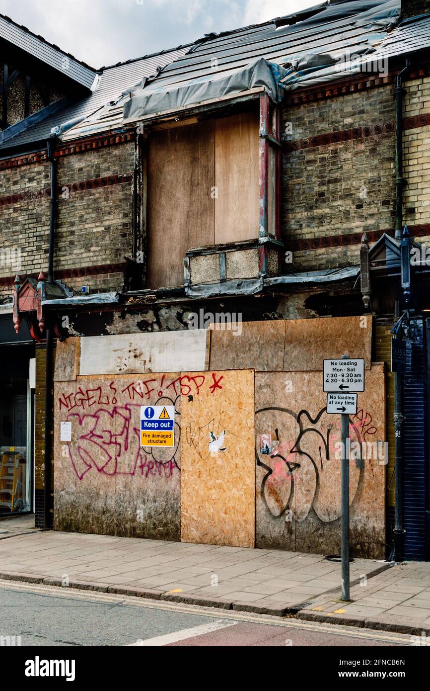 The burnt out and boarded up shell of Mr Gee's electrical shop on Mill ...