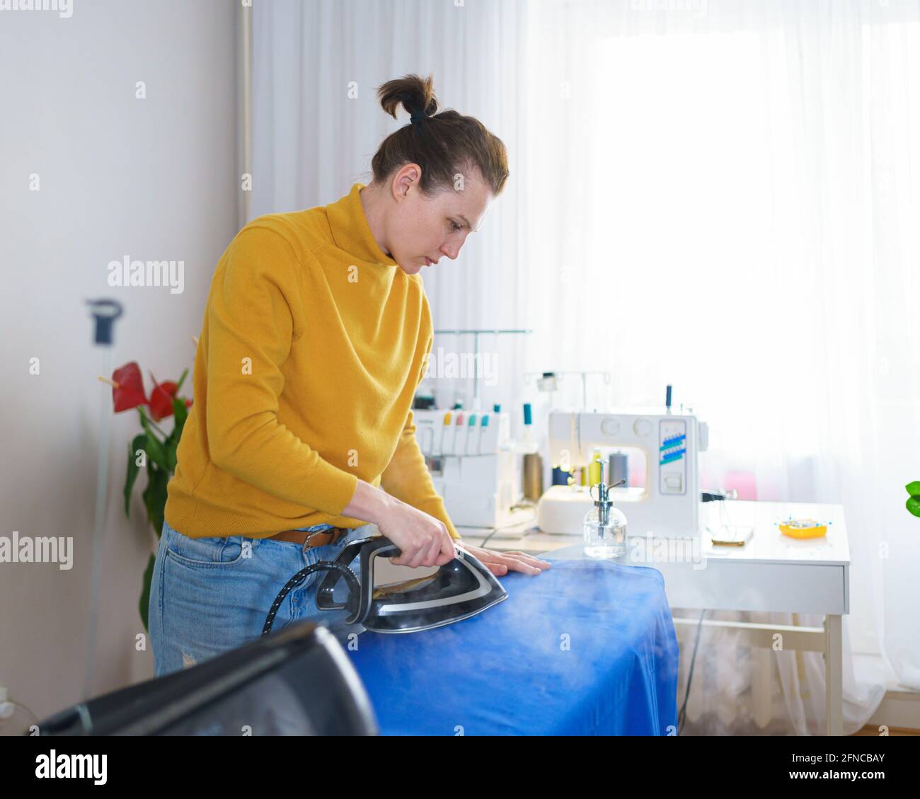 Focused woman sewing machine in hi-res stock photography and images - Alamy