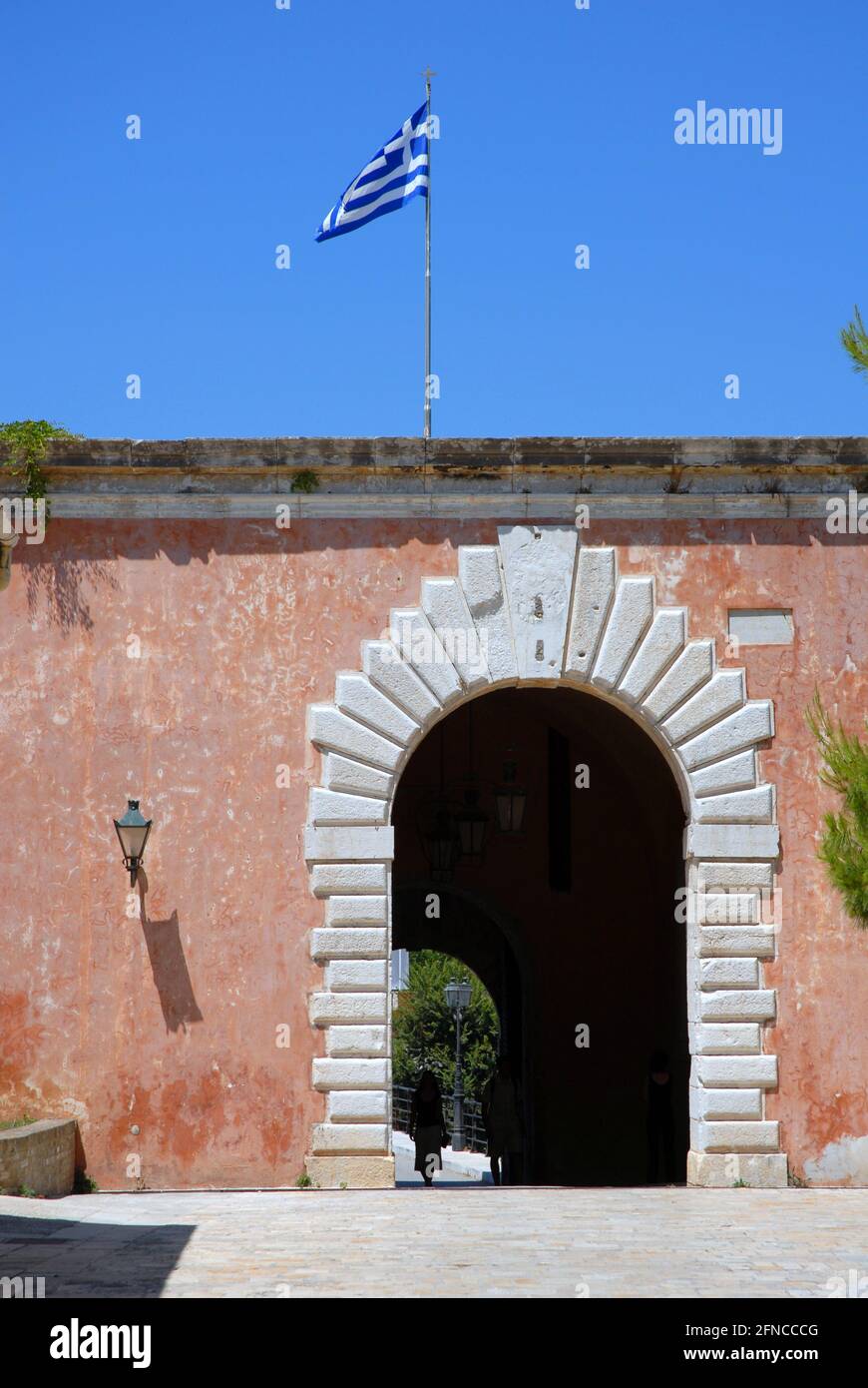Arched entrance with Greek national flag flying above, Corfu town ...