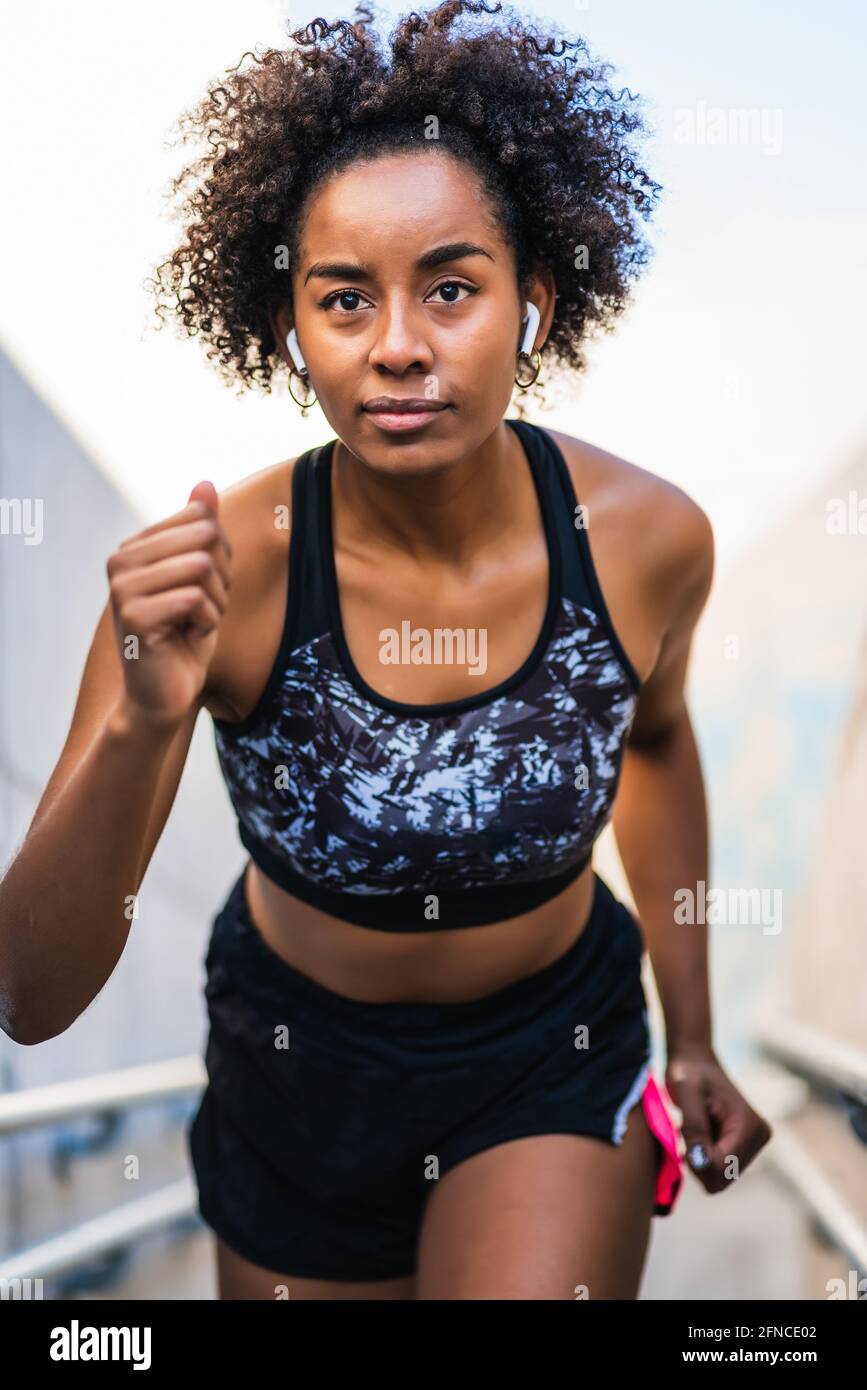 Afro athlete woman running outdoors Stock Photo - Alamy