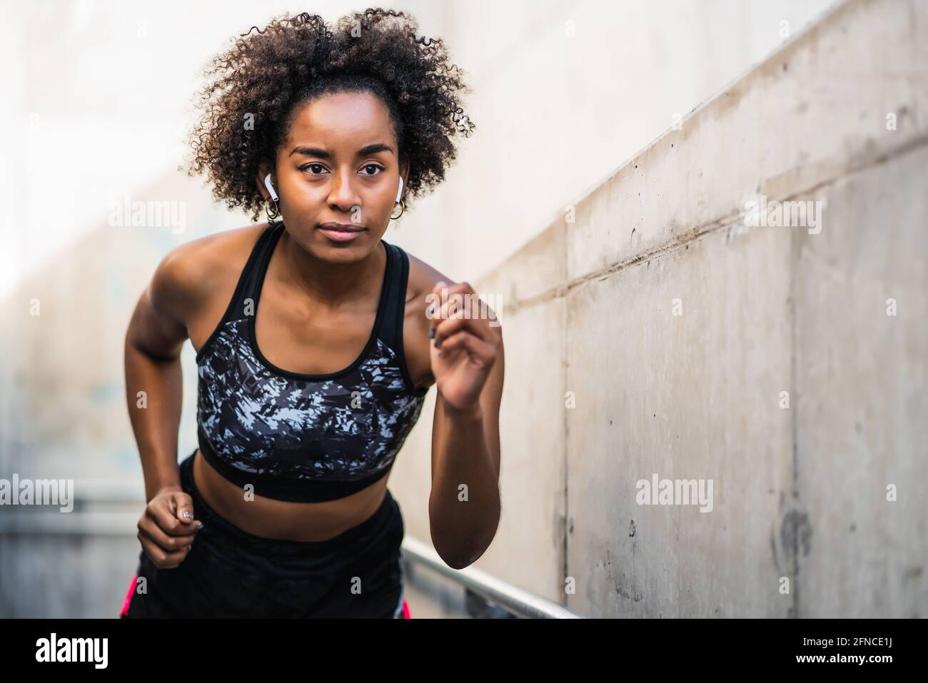 Afro athlete woman running outdoors Stock Photo - Alamy