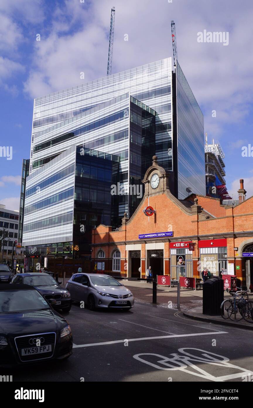 London, United Kingdom: vehicles passing in front of Hammersmith tube ...