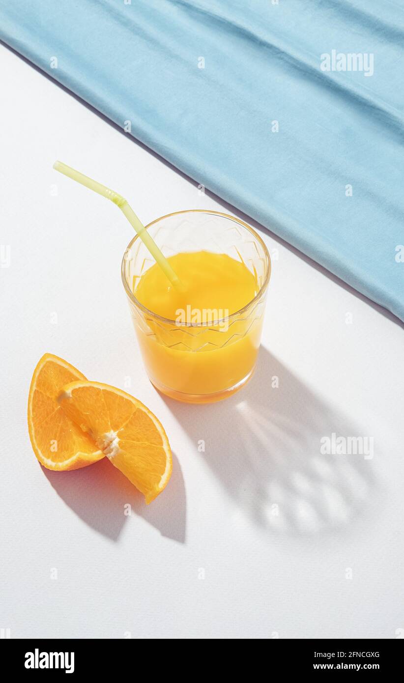 Orange juice and two parts of an orange in the sun - A simple ...