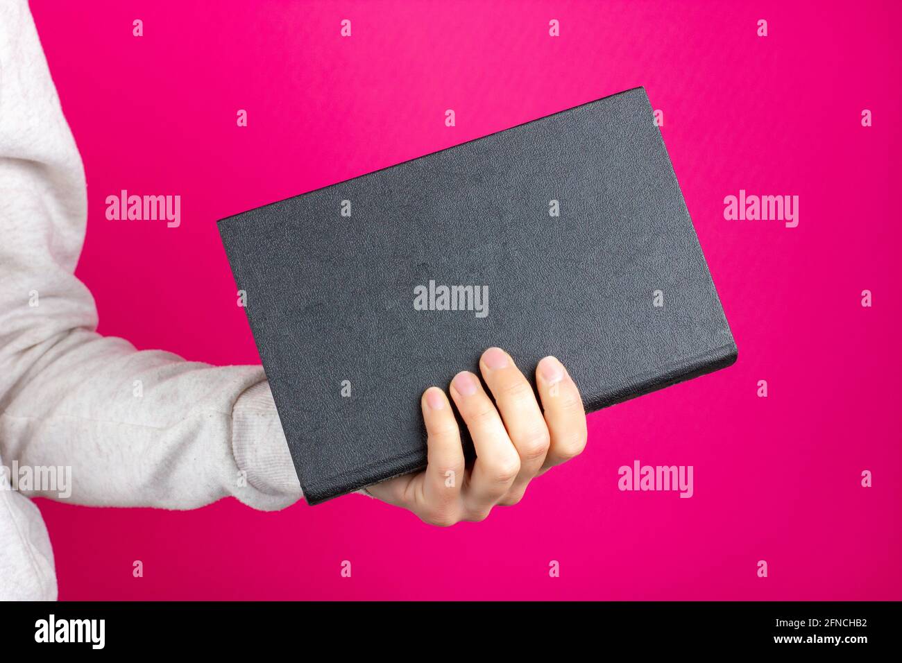 Person showing a book hi-res stock photography and images - Alamy