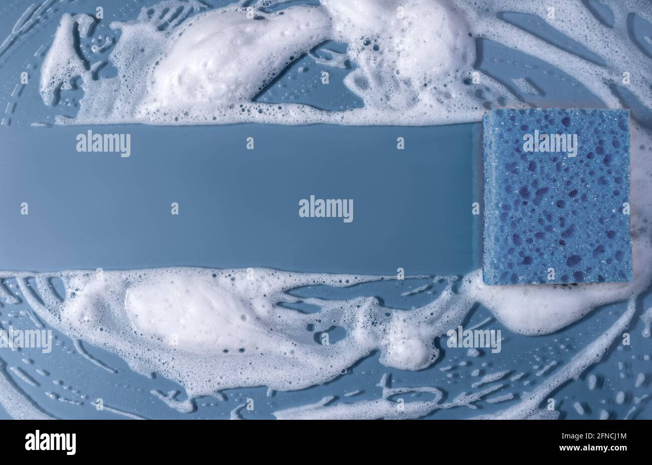Cleaning sponge with soap. Texture with bubble suds on blue background ...