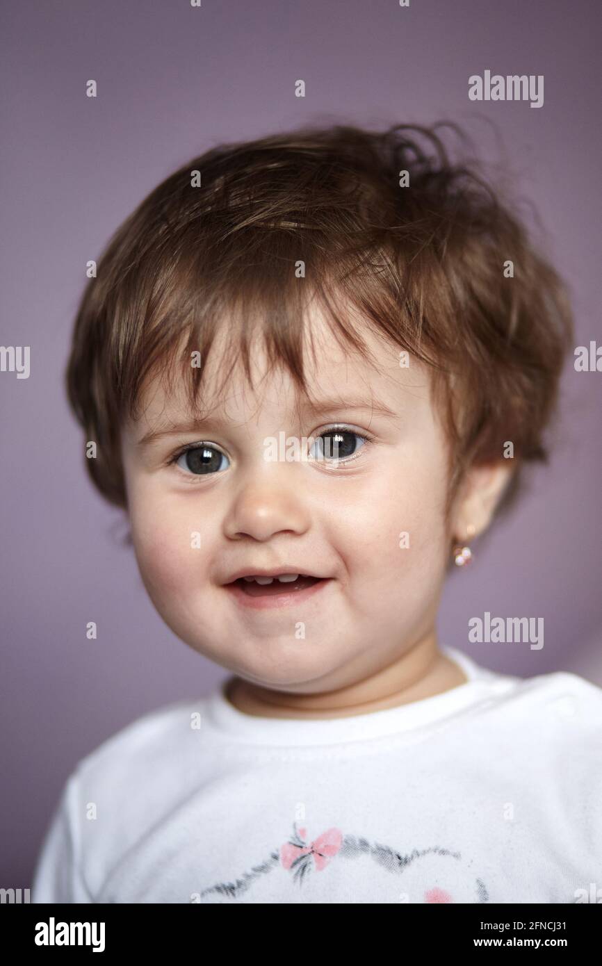 Portrait of cute adorable smiling Caucasian baby girl one year old ...