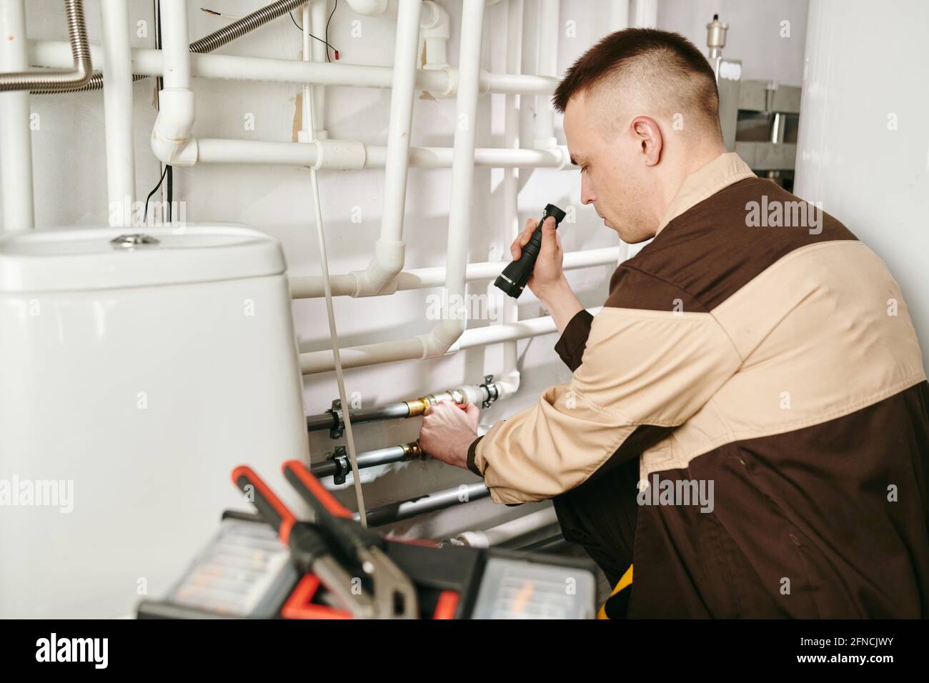 Men at work repairing a pipe hi-res stock photography and images - Alamy