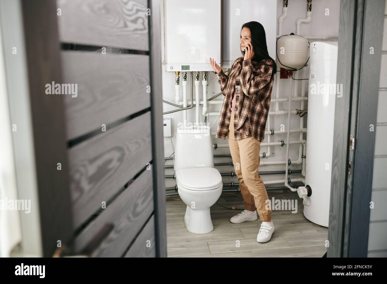 A person standing in toilet and talking on smartphone Stock Photo - Alamy