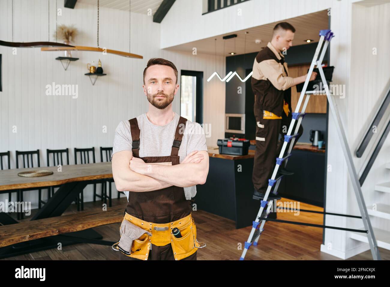 Two men on ladder one hi-res stock photography and images - Alamy