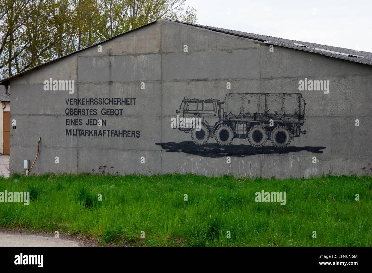 Facade of old GDR NVA military garage. The German text translates to ...